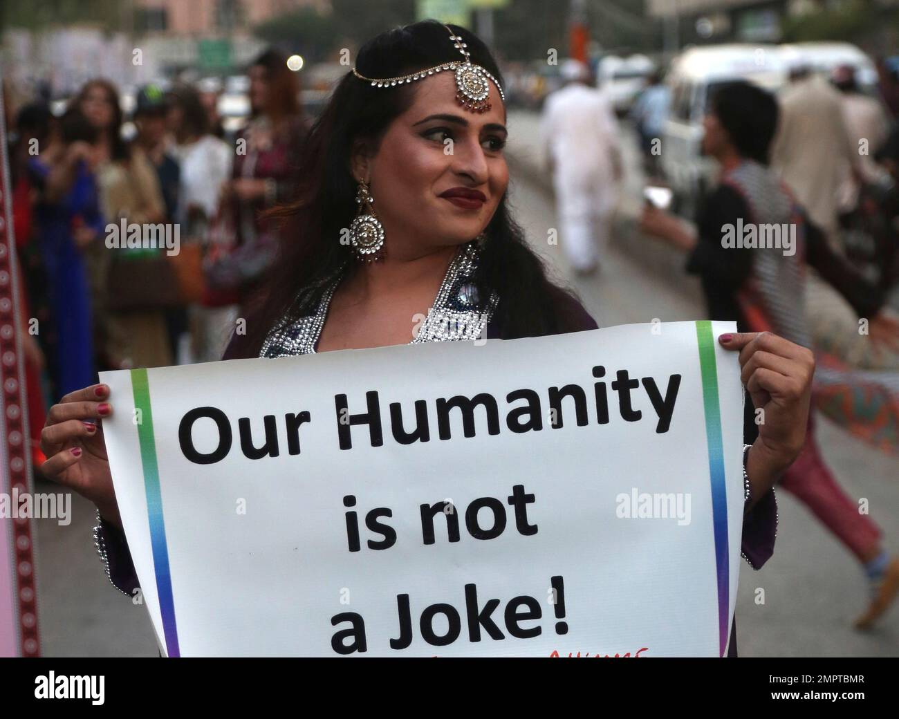 A member of the Pakistani transgender community holds up a sign, during ...