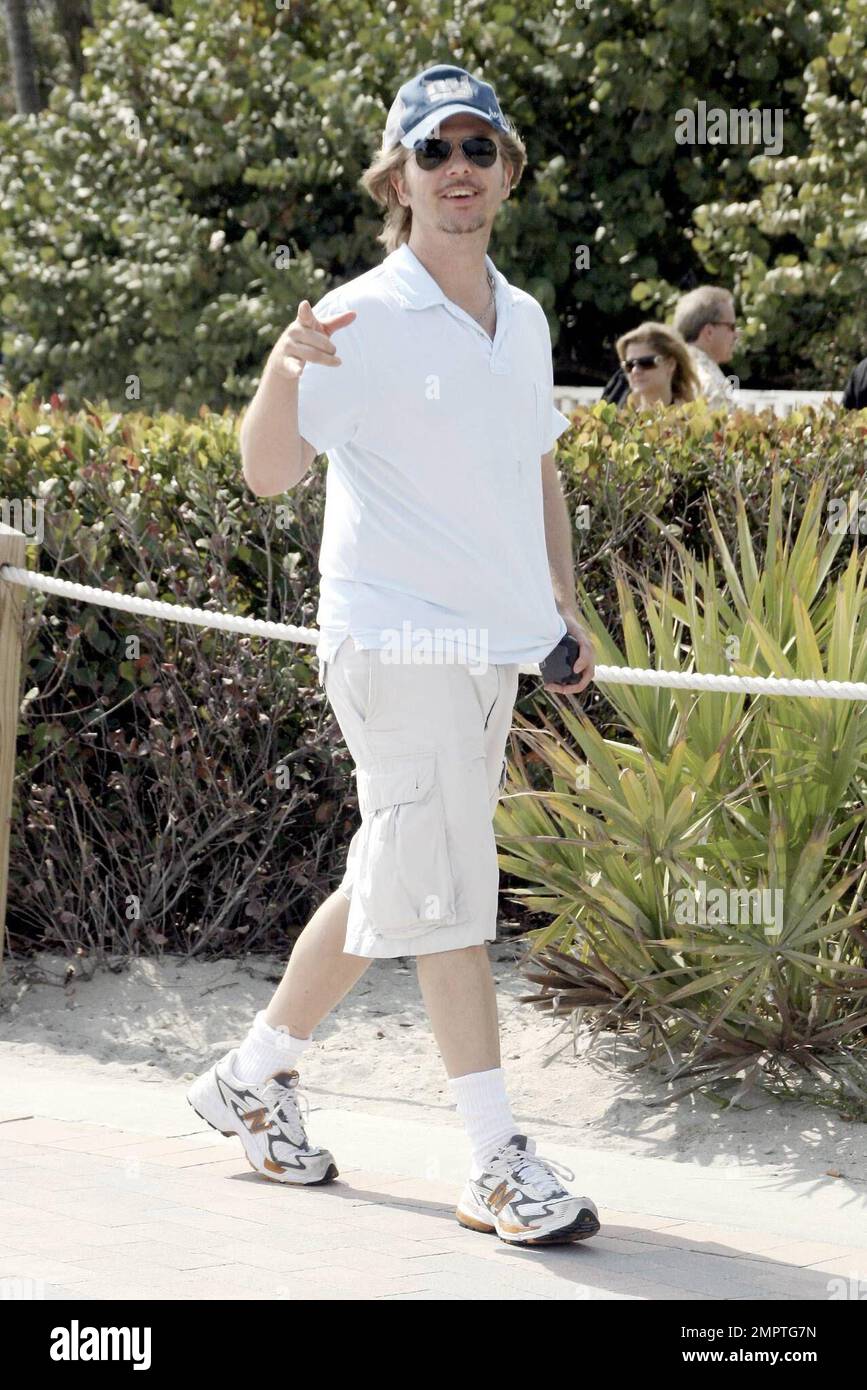 Comedian David Spade plays up to the camera as he enjoys a walk in the ...