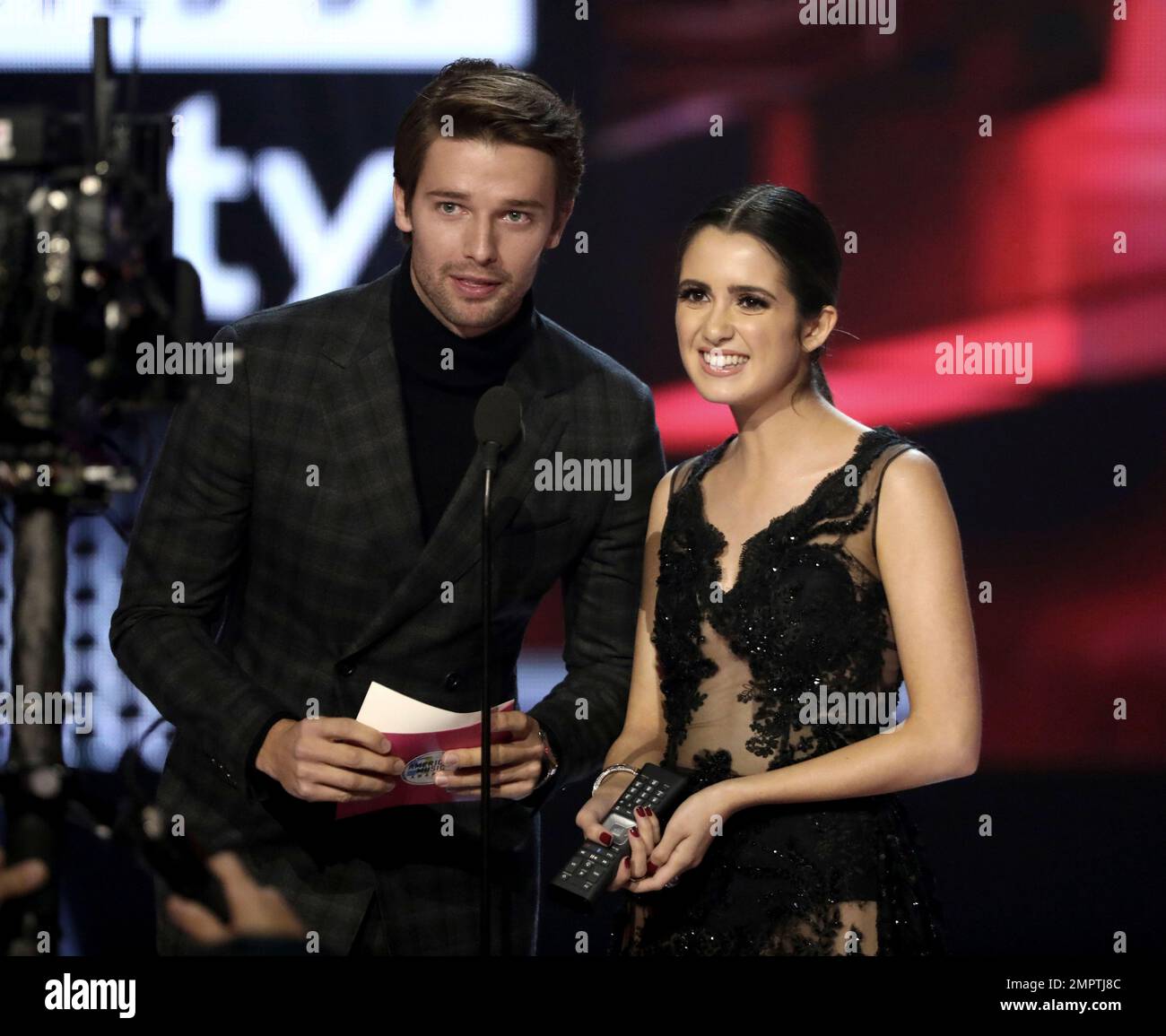 Patrick Schwarzenegger, left, and Laura Marano present the award for ...