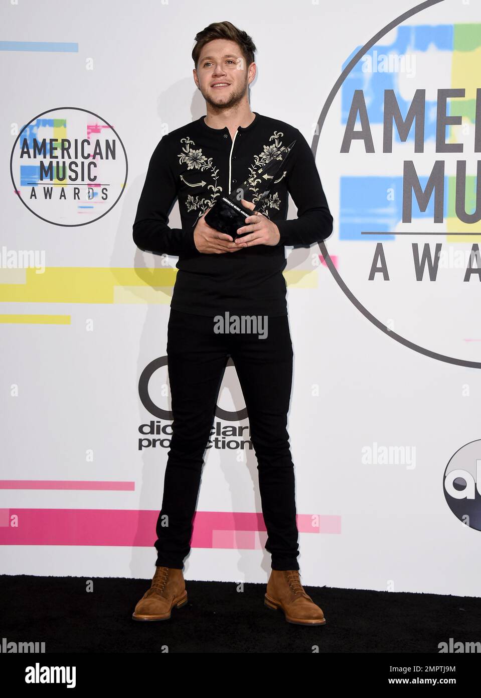 Niall Horan poses in the press room with the award for new artist of ...