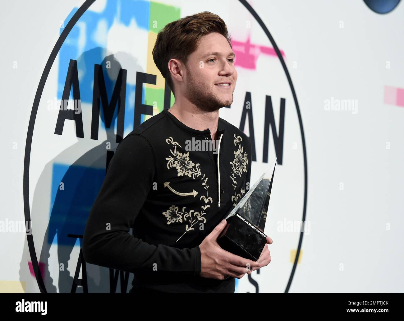 Niall Horan poses in the press room with the award for new artist of ...