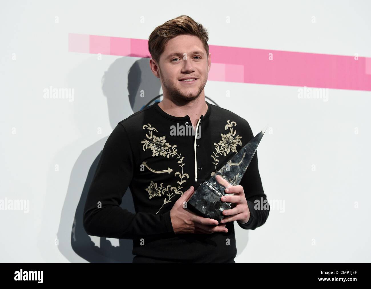 Niall Horan poses in the press room with the award for new artist of ...