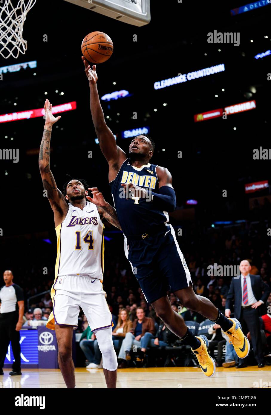 Denver Nuggets forward Paul Millsap, right, goes up for a layup as Los ...
