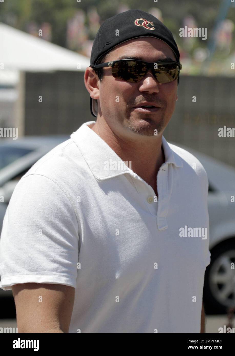 Dean Cain looks casual in a black cap turned backwards, white shirt and ...