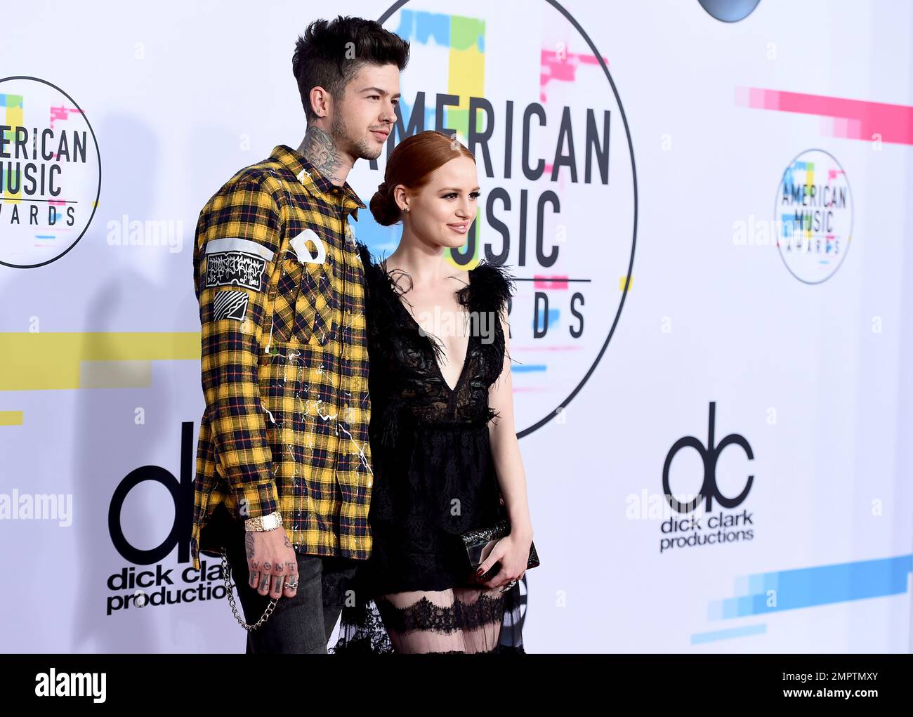 Travis Mills, left, and Madelaine Petsch arrive at the American Music ...