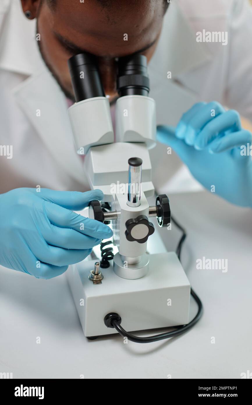 Researcher working with microscope in medical office Stock Photo - Alamy
