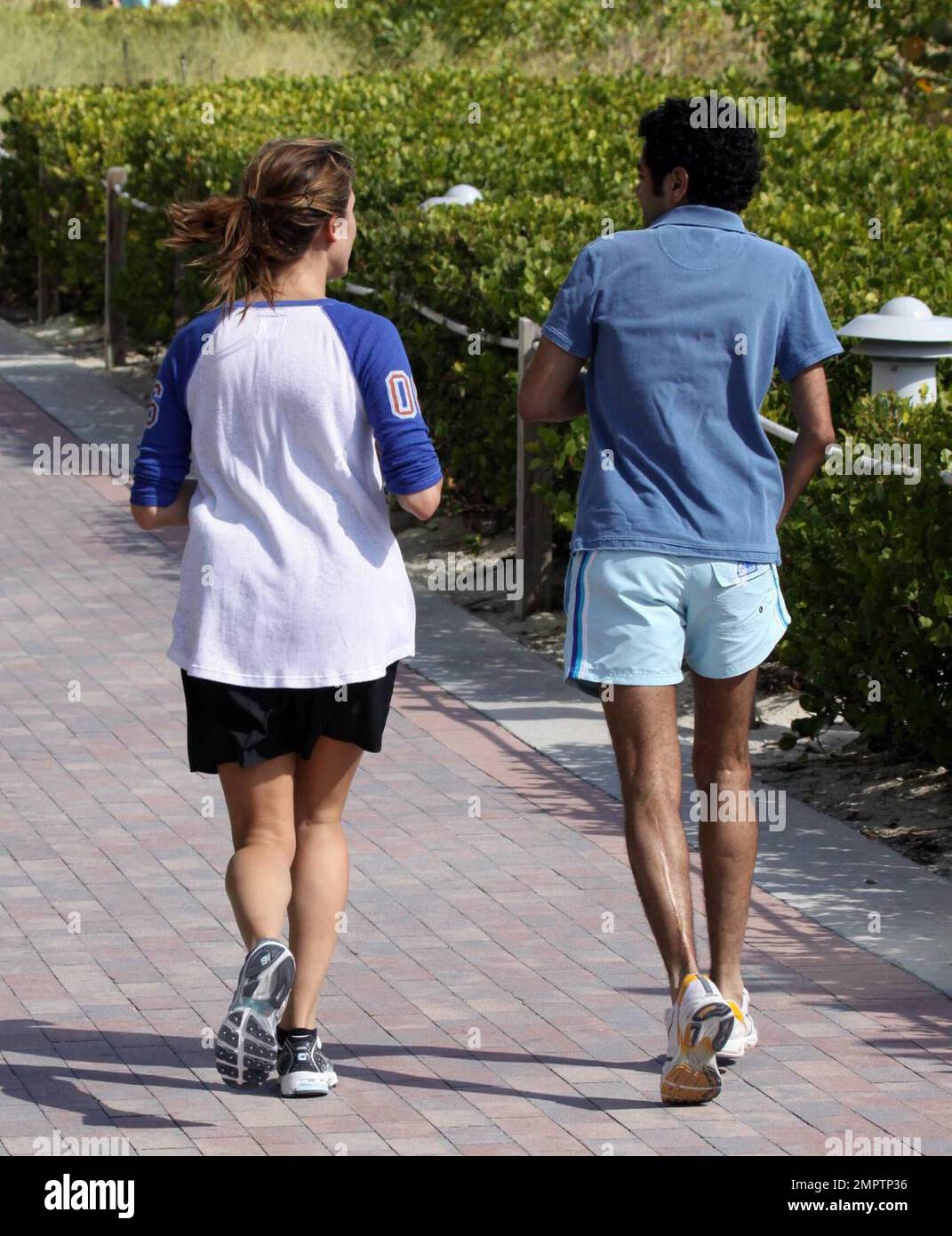 Jamel Debbouze and Melissa Theuriau go for a jog. Debbouze's legs show ...