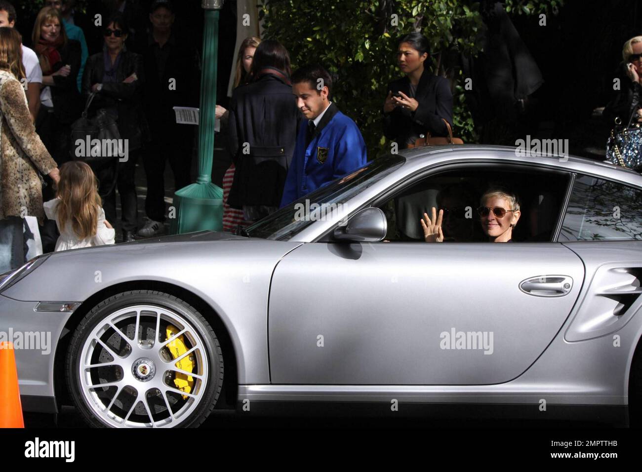 Former Oscar host Ellen DeGeneres and wife Portia De Rossi smile and ...