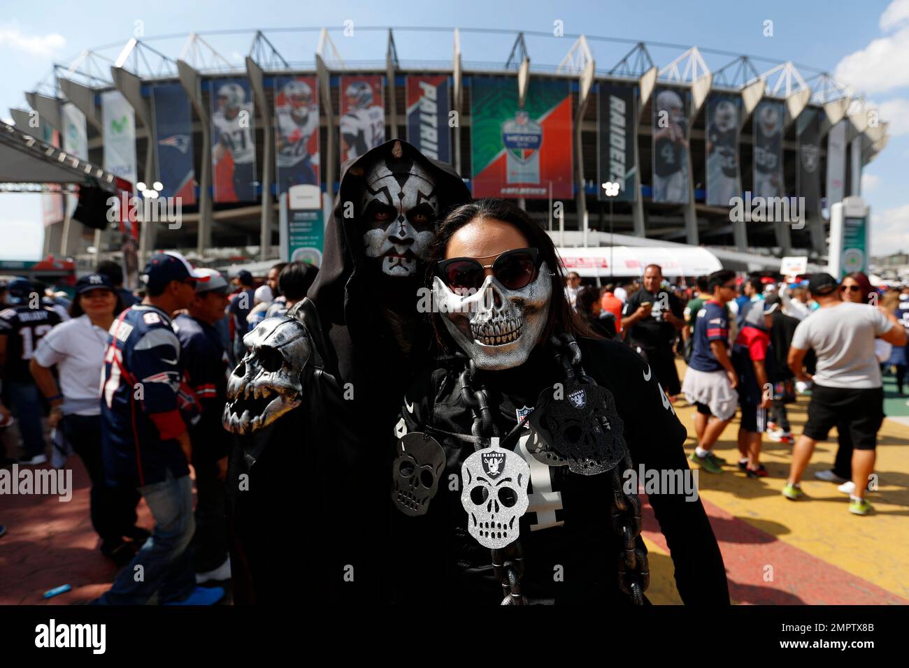 Oakland Raiders fans pose for pictures in front of Azted Stadium before ...