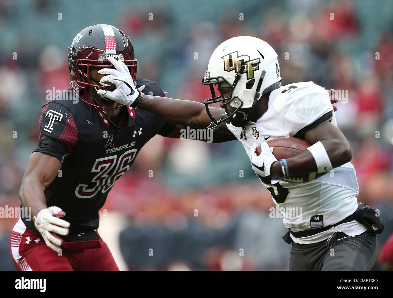 Central Florida running back Adrian Killins Jr. stiff arms Temple's Sam ...