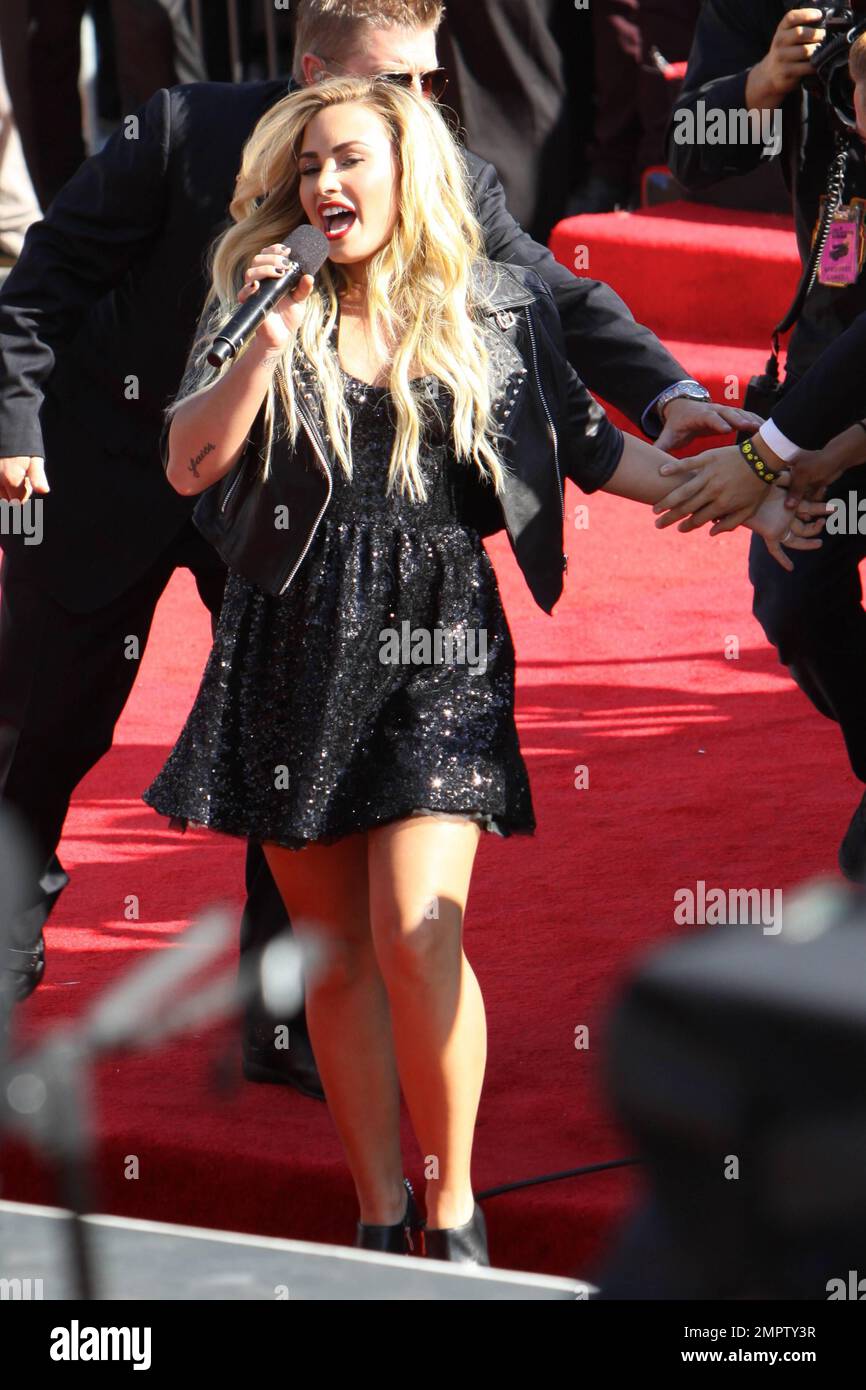 Wearing a black sequenced mini dress with a leather jacket and black ...