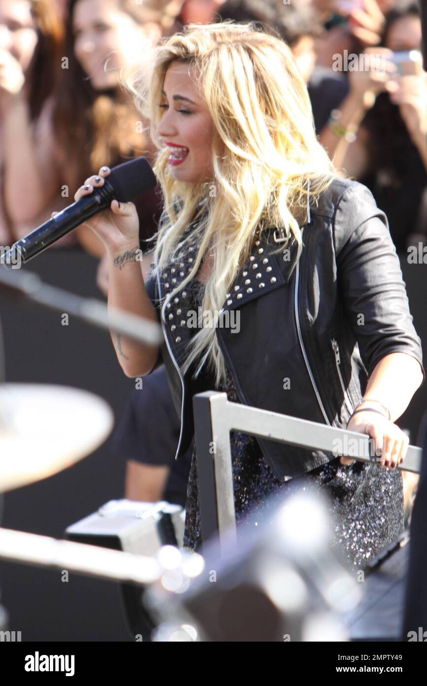 Wearing a black sequenced mini dress with a leather jacket and black ...