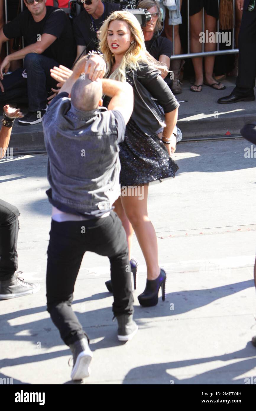 Wearing a black sequenced mini dress with a leather jacket and black ...