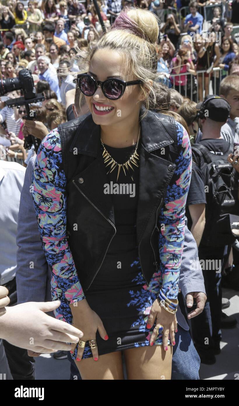 Judge Demi Lovato wears a floral patterned black dress with a black ...