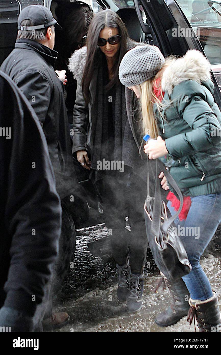 Demi Moore keeps warm in a grey jacket, jeans and lace-up boots while ...