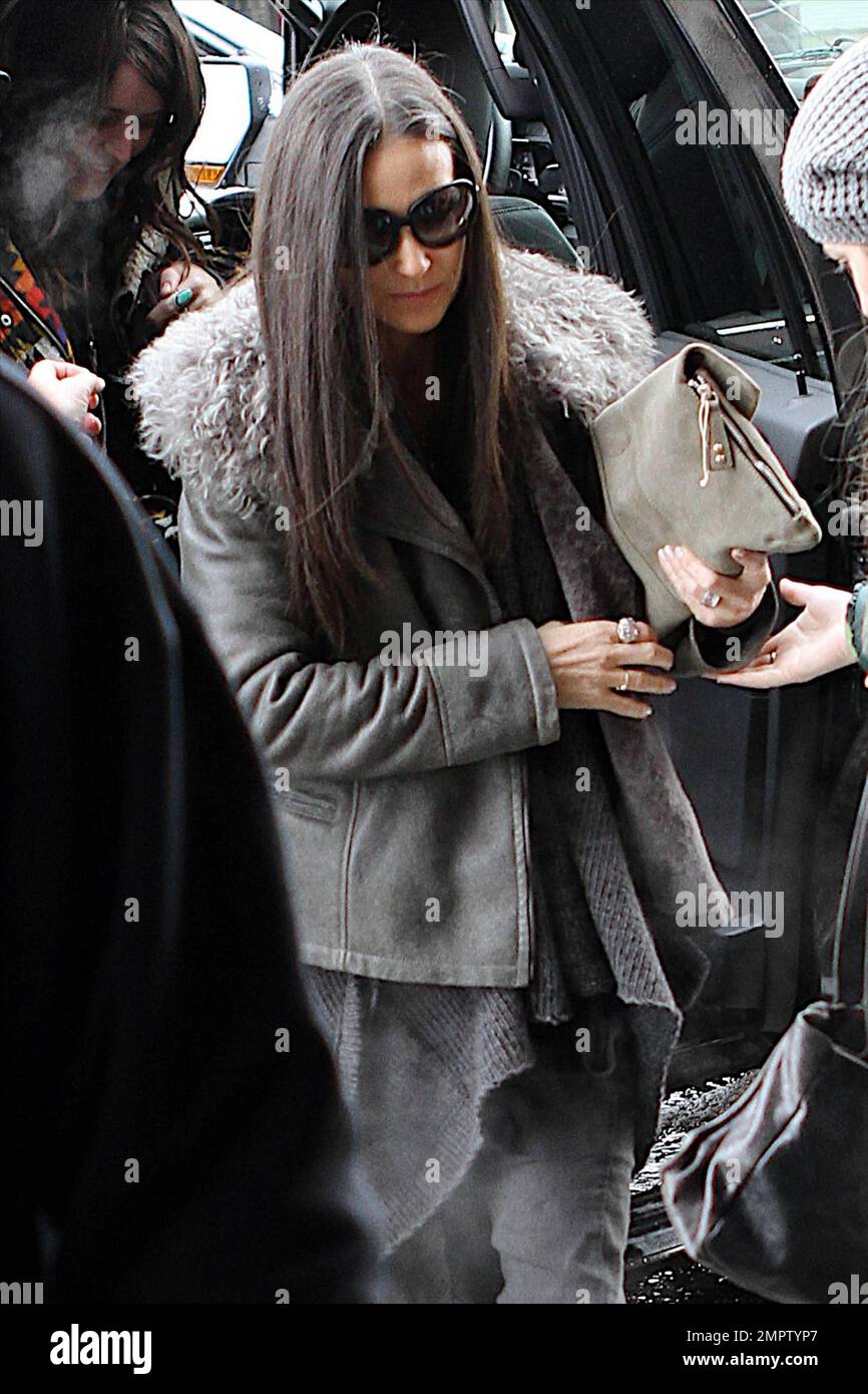 Demi Moore keeps warm in a grey jacket, jeans and lace-up boots while ...