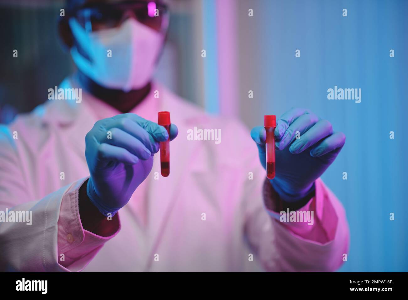 Laboratory worker holding samples with blood of sick patient Stock ...