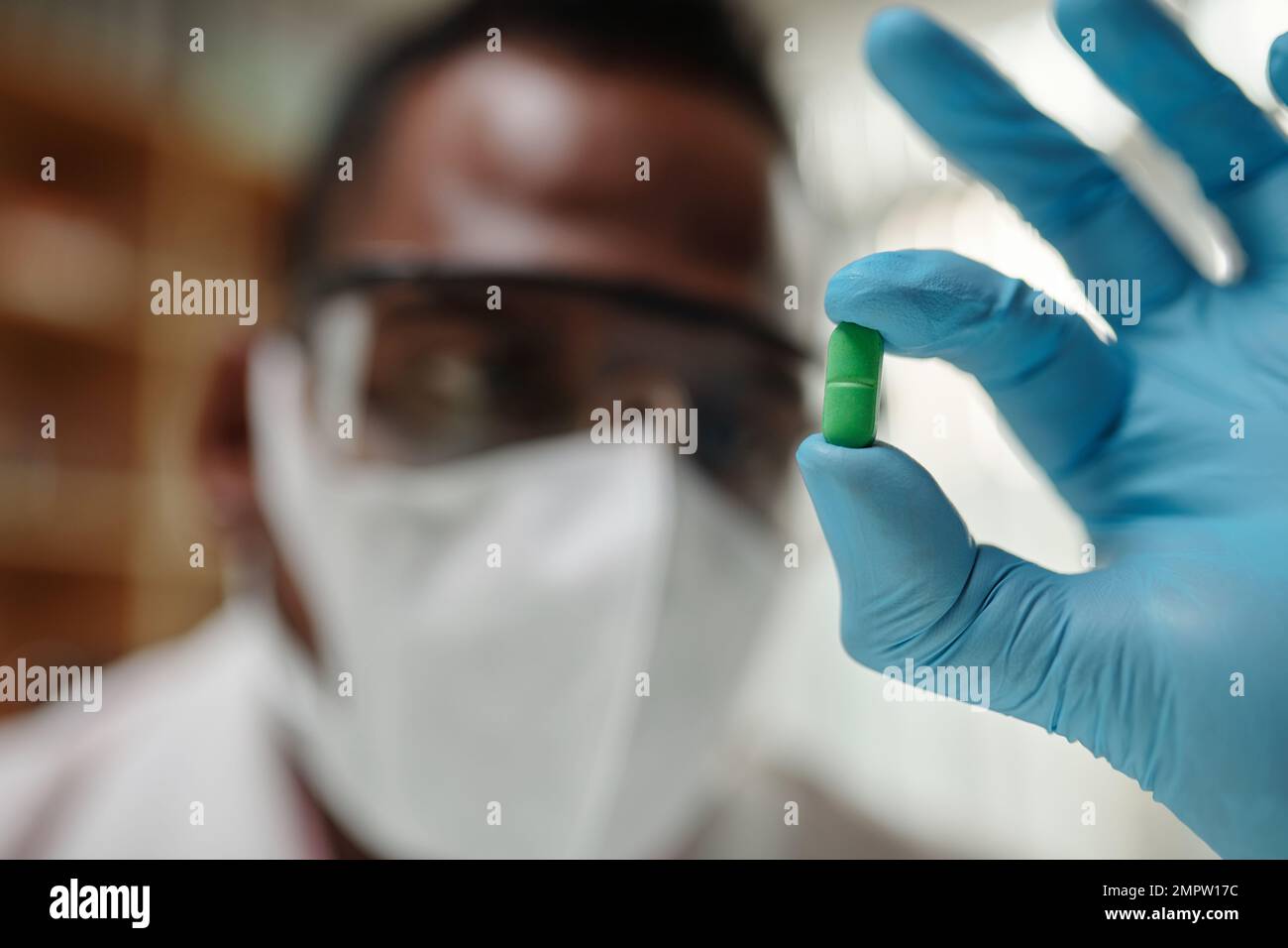 Closeup image of scientist showing pill with new innovative medicine he ...