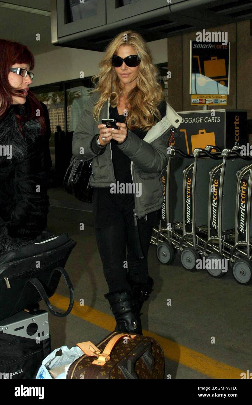 A cheerful Denise Richards is seen arriving at LAX on a cool and cloudy ...