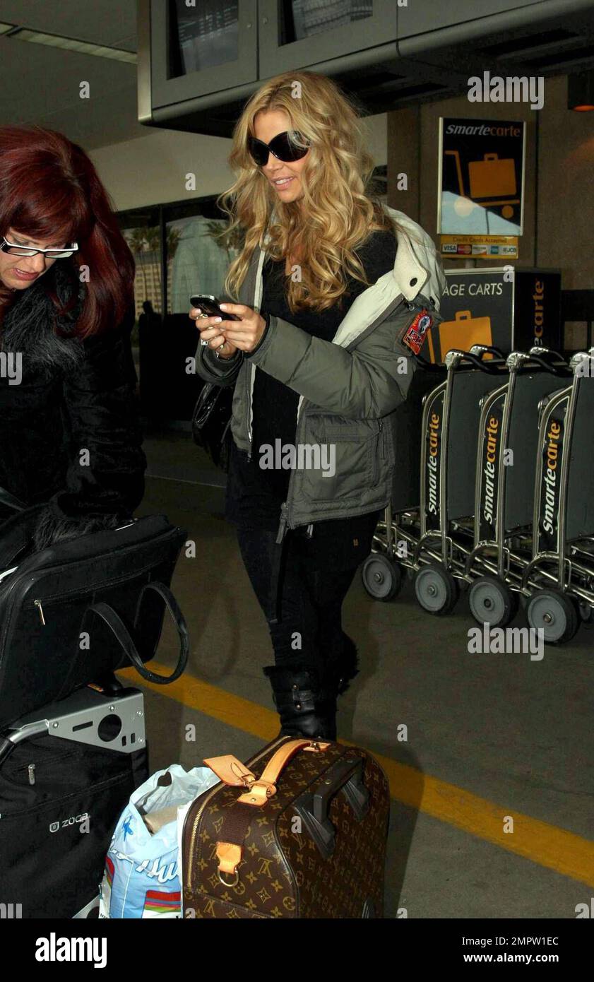 A cheerful Denise Richards is seen arriving at LAX on a cool and cloudy ...