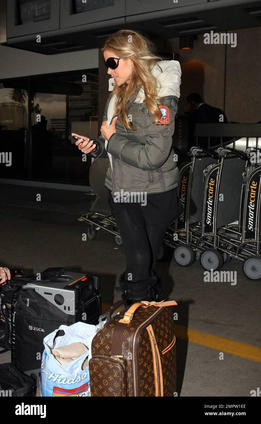 A cheerful Denise Richards is seen arriving at LAX on a cool and cloudy ...