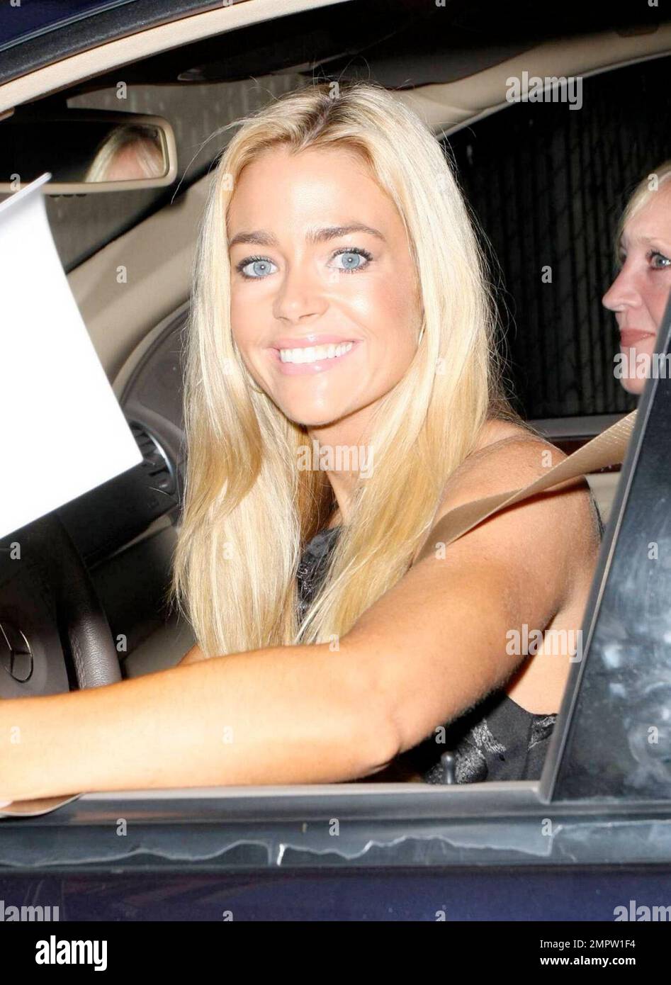 Actress Denise Richards signs autographs for fans as she leaves the ...