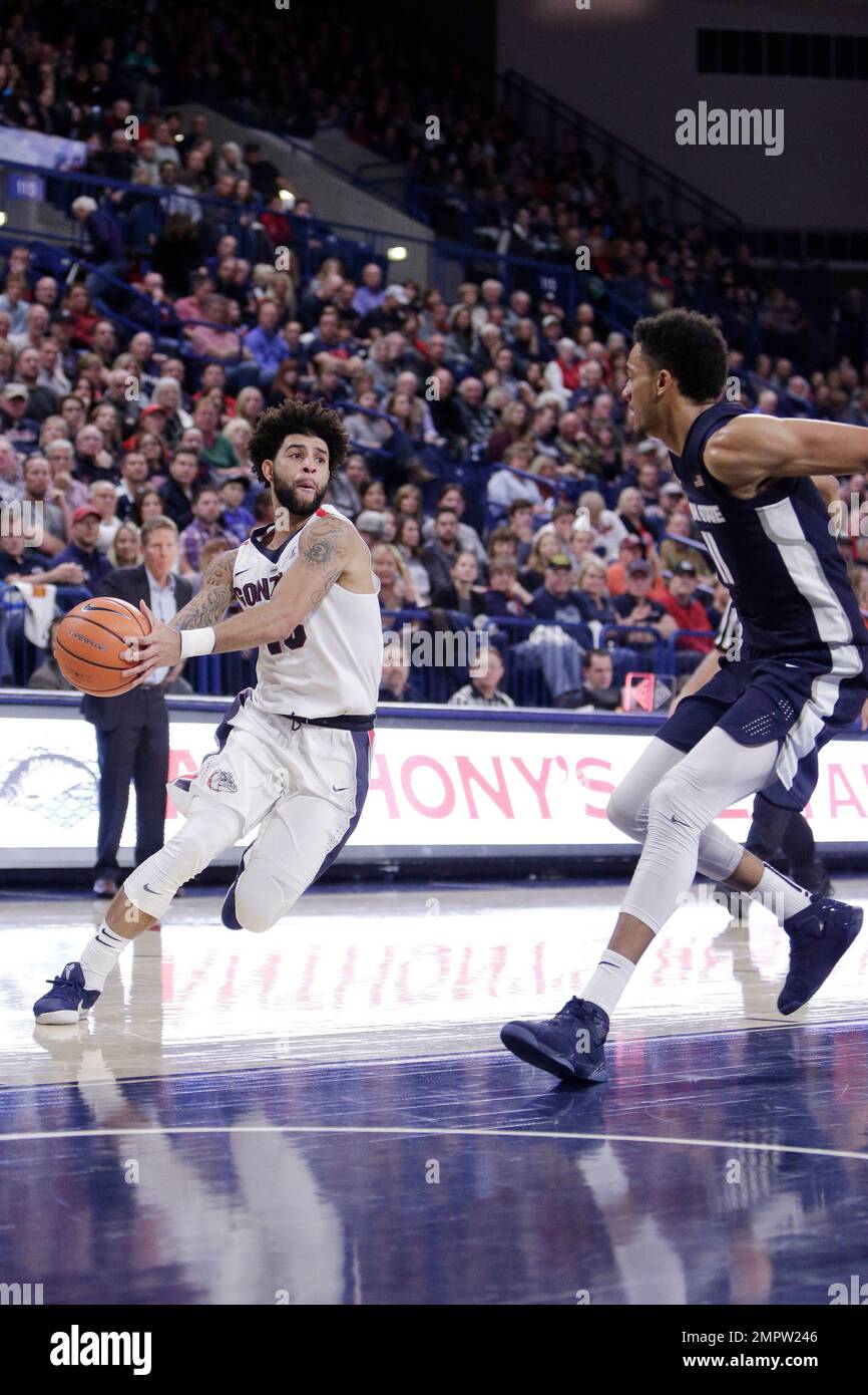 Gonzaga guard Josh Perkins, left, drives against Utah State forward ...