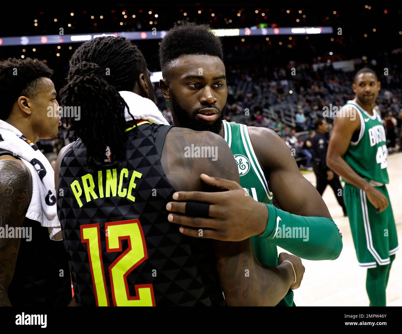 Boston Celtics' Jaylen Brown, center right, hugs Atlanta Hawks' Taurean ...