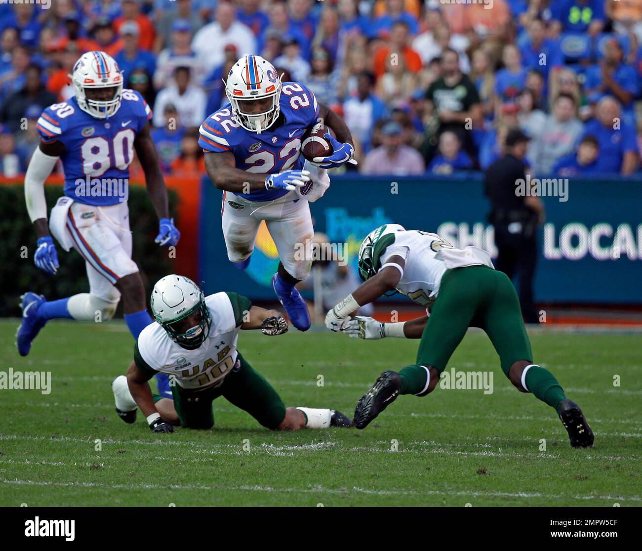 Florida running back Lamical Perine (22) dives over UAB safety Garrison ...