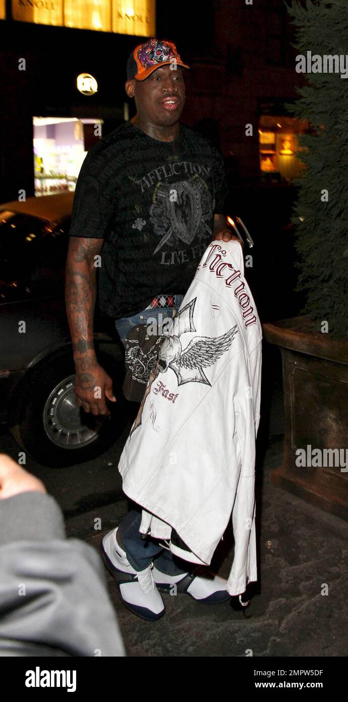 A female passerby looks shocked as she sees Dennis Rodman arriving at ...