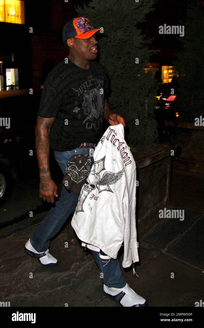 A female passerby looks shocked as she sees Dennis Rodman arriving at ...