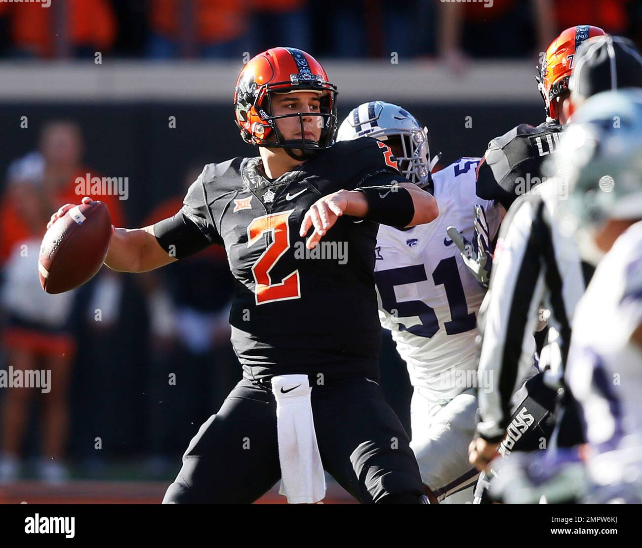 Oklahoma State quarterback Mason Rudolph (2) passes under pressure from ...