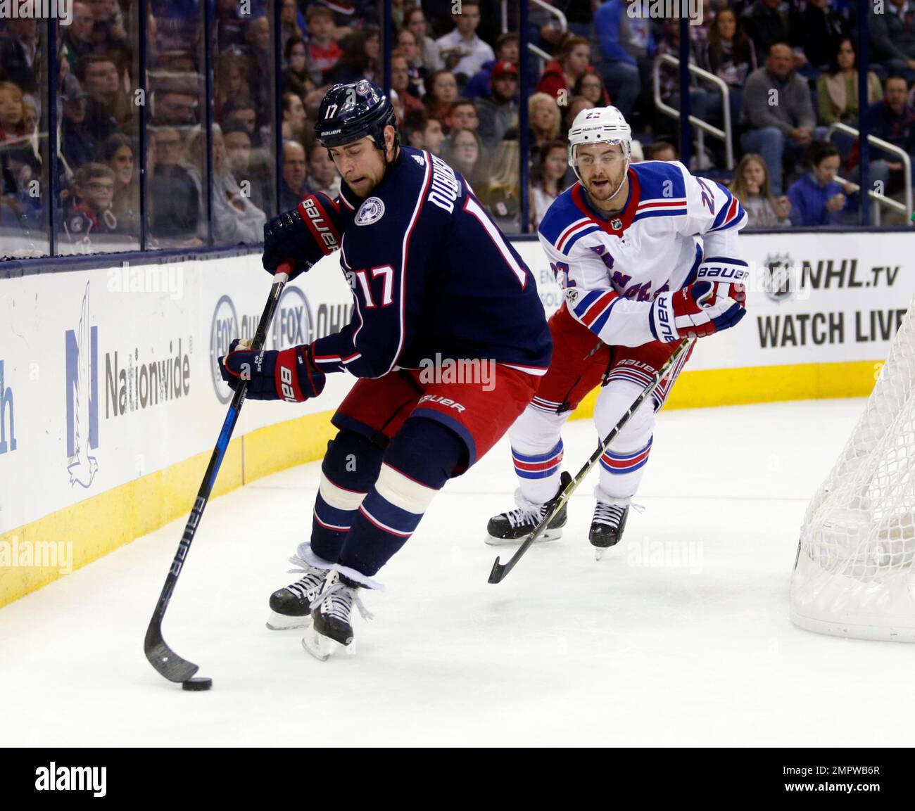 Columbus Blue Jackets forward Brandon Dubinsky, left, controls the puck ...