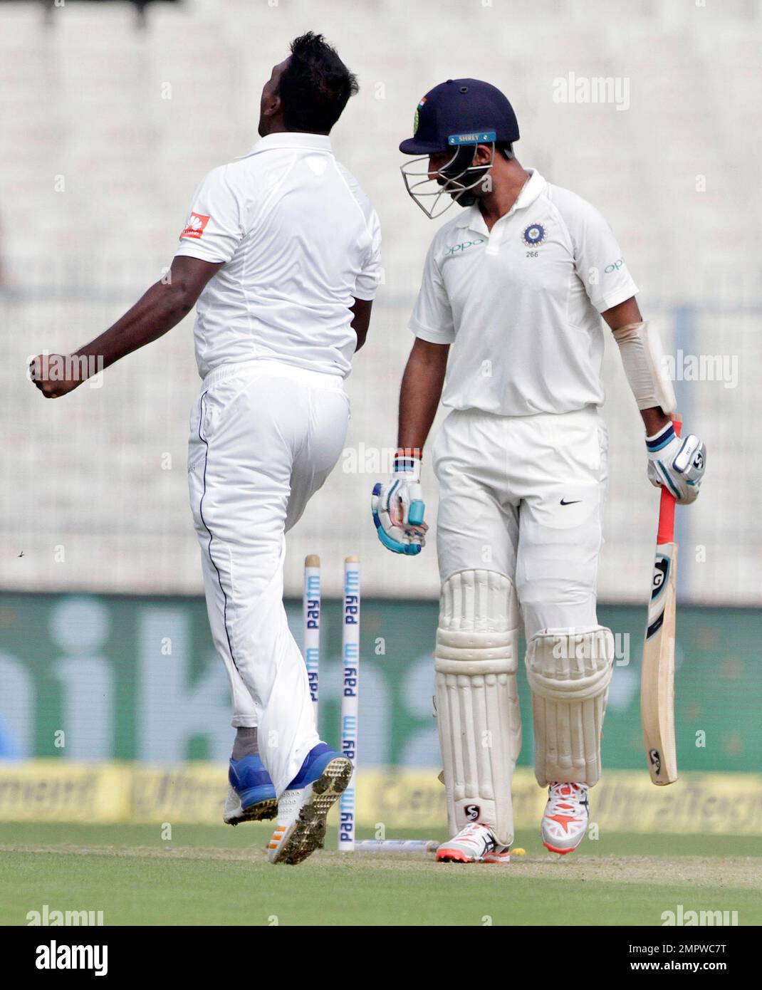 Sri Lanka's Lahiru Gamage, left, celebrates the dismissal of India's ...