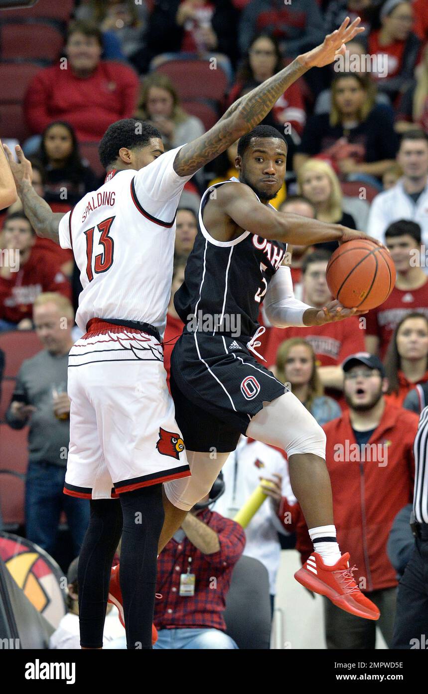 Omaha guard KJ Robinson (5) passes the ball away from the defense of ...