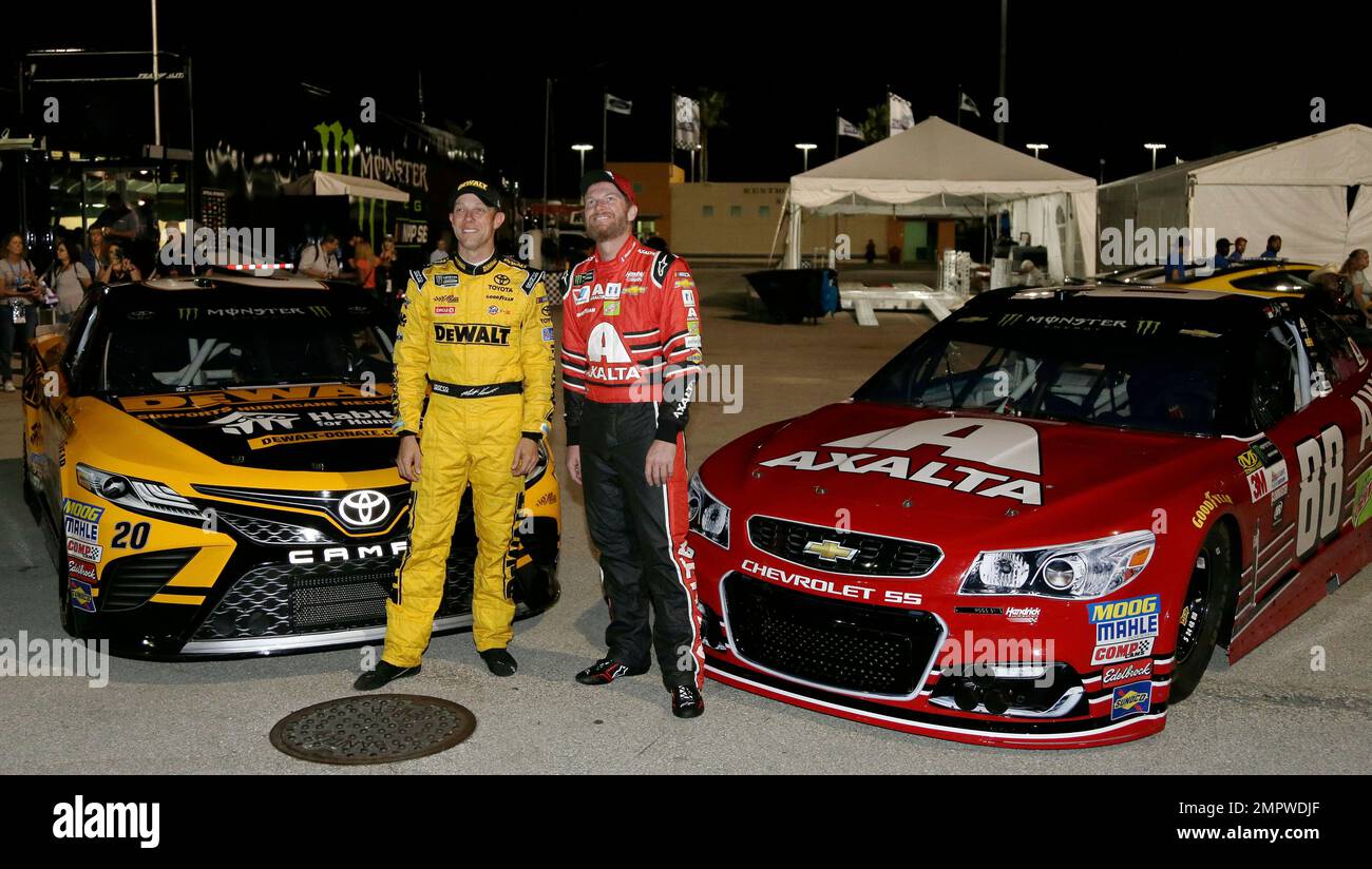 Matt Kenseth, left, and Dale Earnhardt Jr. pose for photos by their cars after qualifying for ...