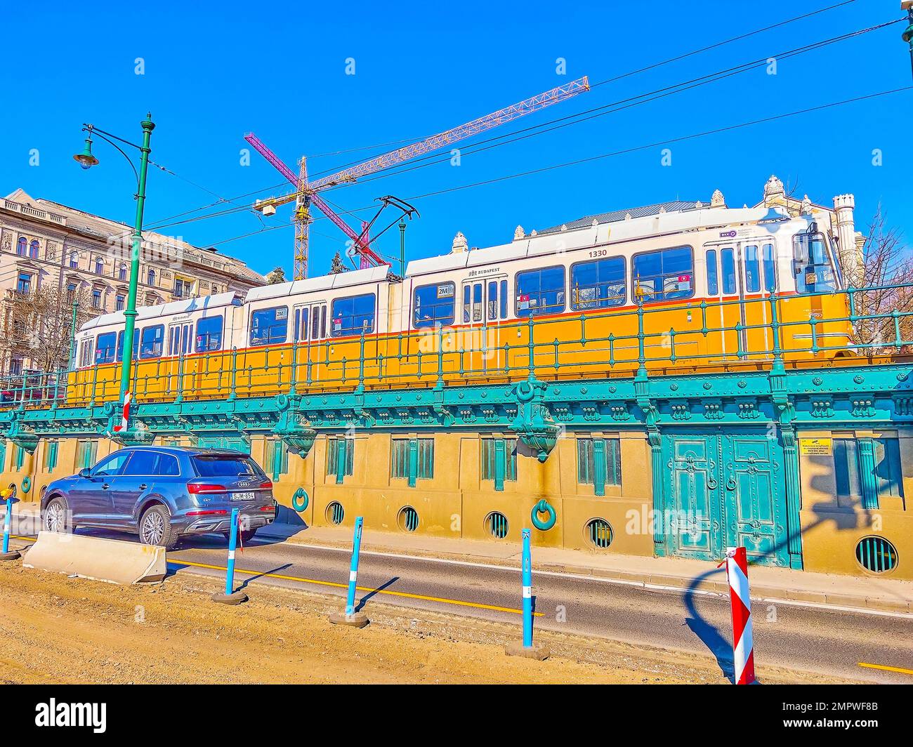 BUDAPEST, HUNGARY - MARCH 2, 2022: The yellow tram rides on Jane ...