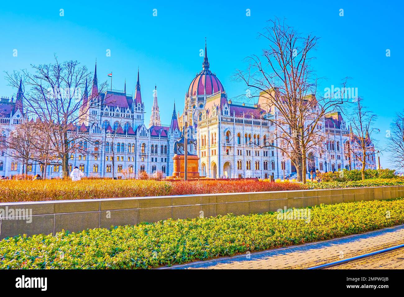 Outstanding Parliament Building through the greenery of Kossuth Lajos ...