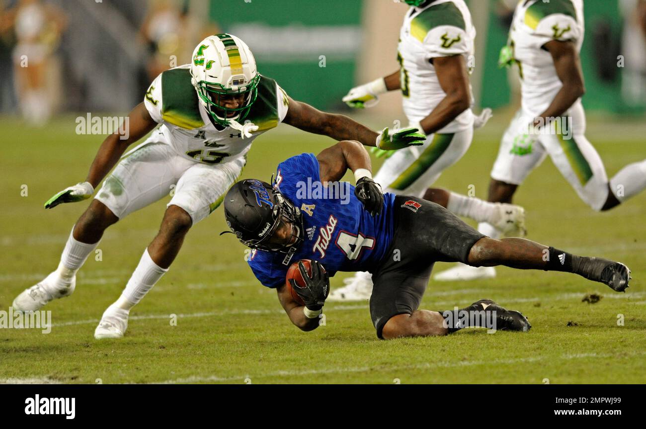 South Florida's Tajee Fullwood (13) tackles Tulsa's D'Angelo Brewer (4 ...