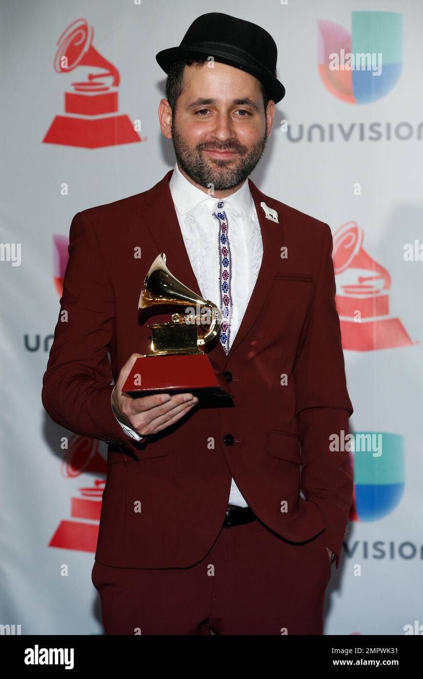 Eduardo Cabra poses in the press room with the award for producer of ...