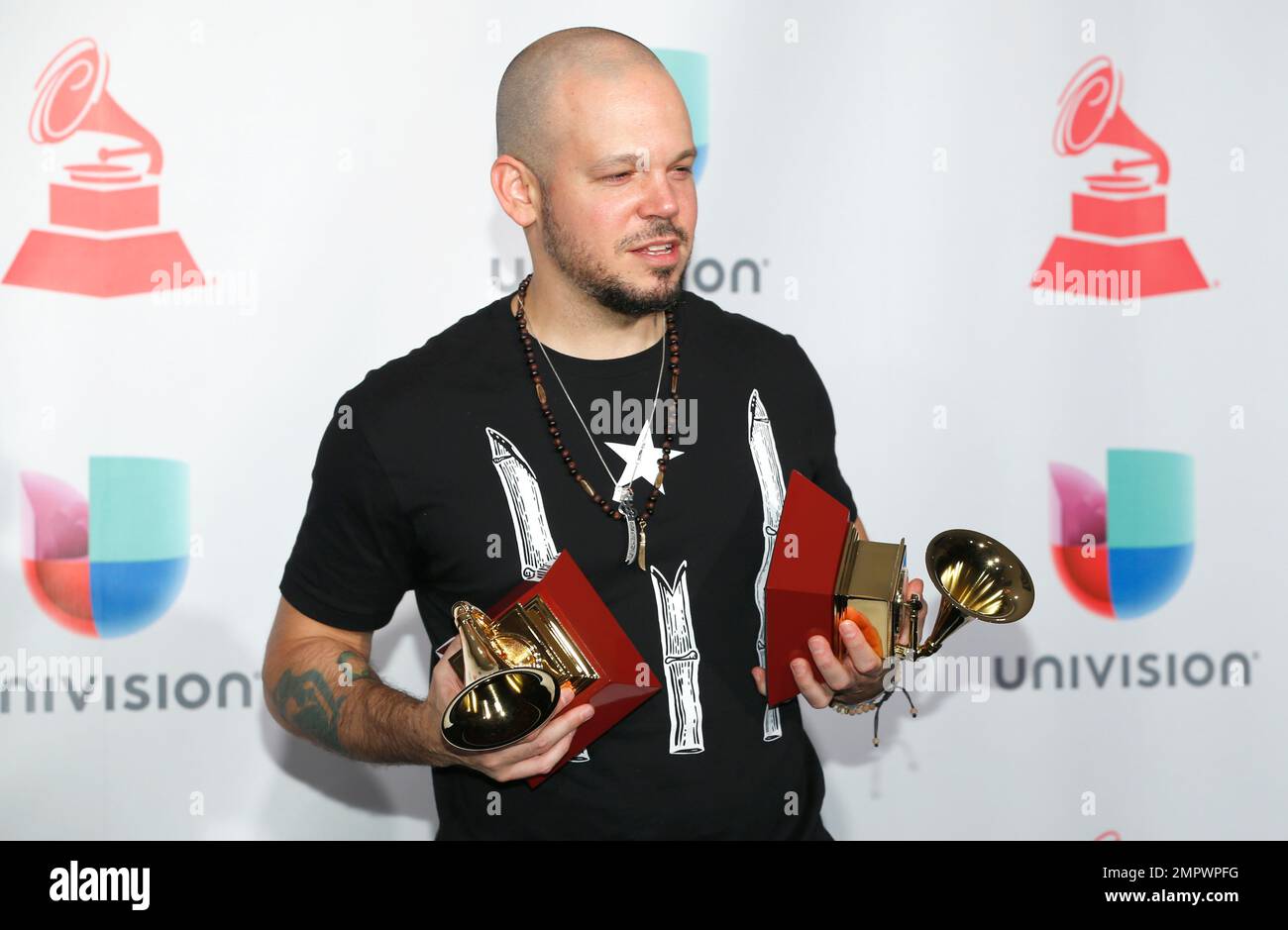 Residente poses in the press room with the award for best urban music ...