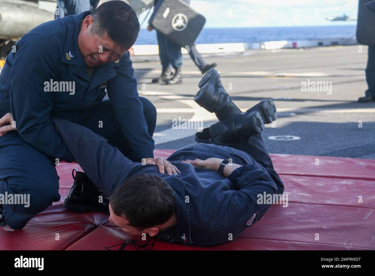 PACIFIC OCEAN (Nov. 19, 2022) Navy Counselor 1st Class Leo Zhang, left ...