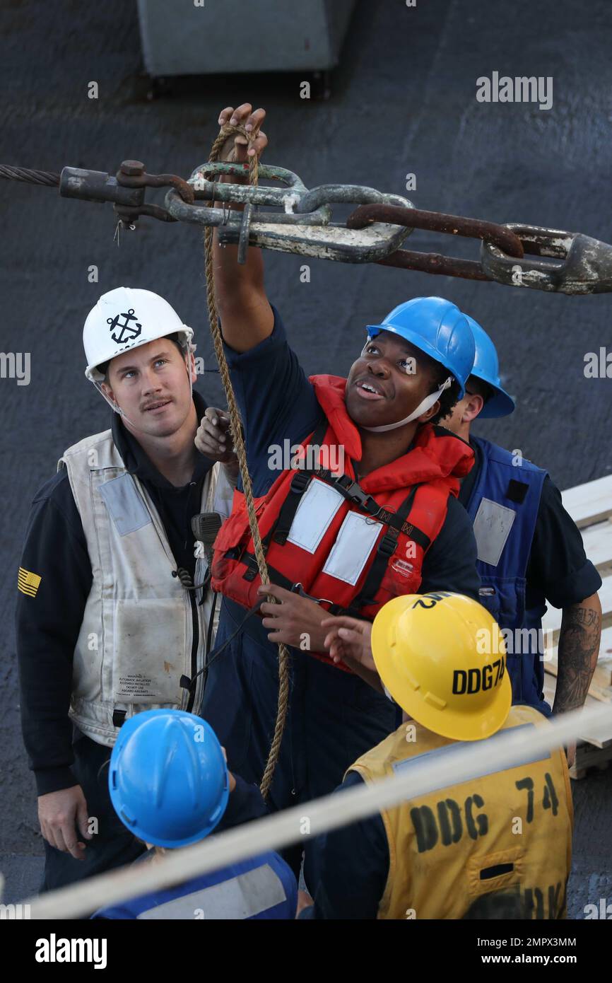 Information Systems Technician 2nd Class Victor Chidi hooks up an ...