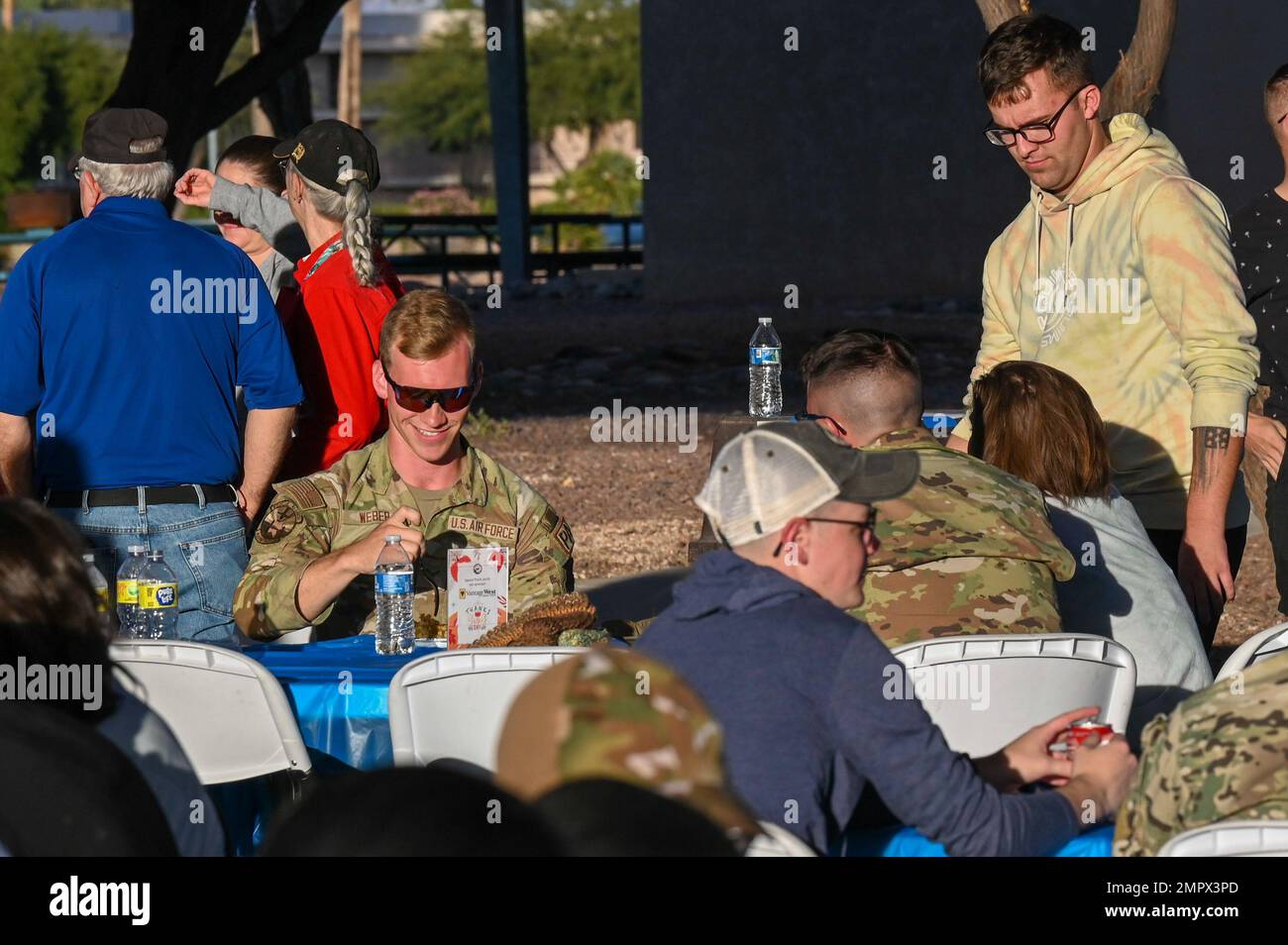 Members of the Desert Lightning Team share a Thanksgiving meal during a ...