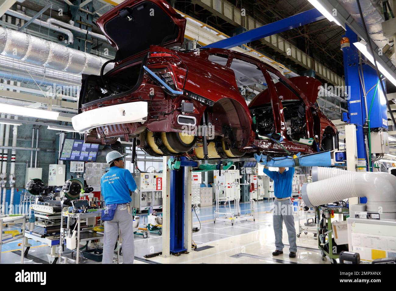 In this Oct. 30, 2017, photo, workers of Toyota Motor Corp. assemble a ...