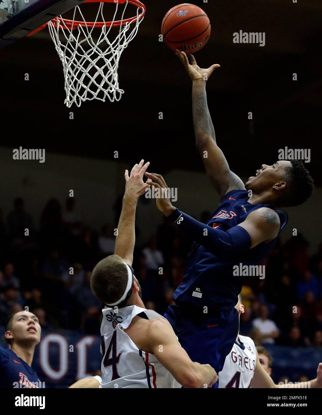 Cal State Fullerton's Khalil Ahmad, right, lays up a shot over Saint ...