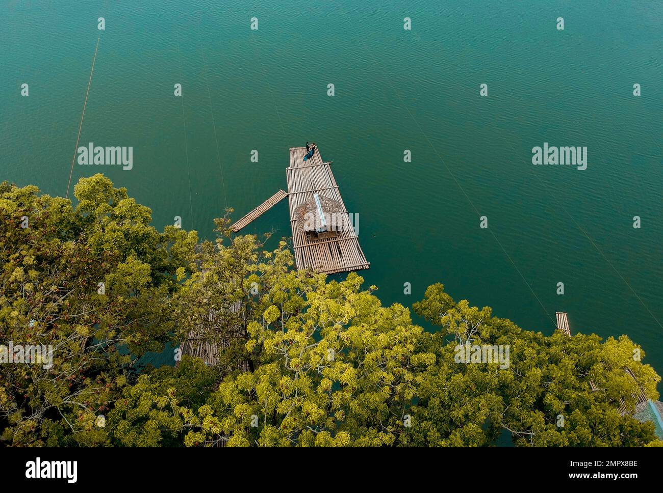 An aerial view of a seascape with a small wooden house floating on the ...