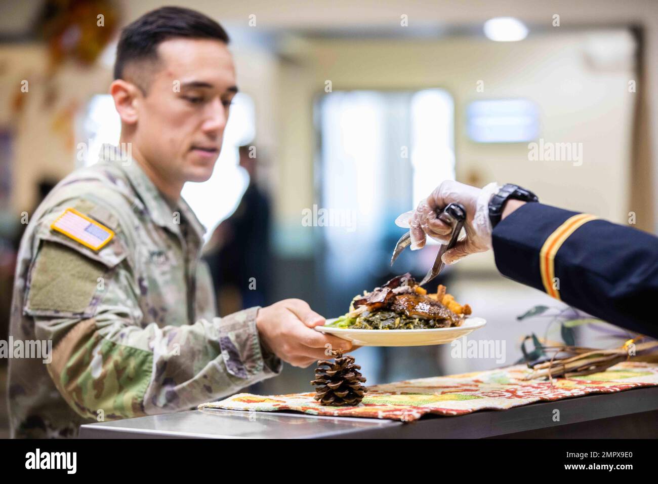A Soldier from 10th Mountain Division receives Thanksgiving food during ...