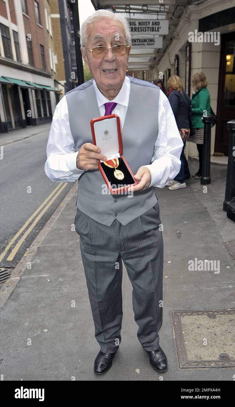 Sir Doug Ellis poses with his knighthood medal, which he received today ...