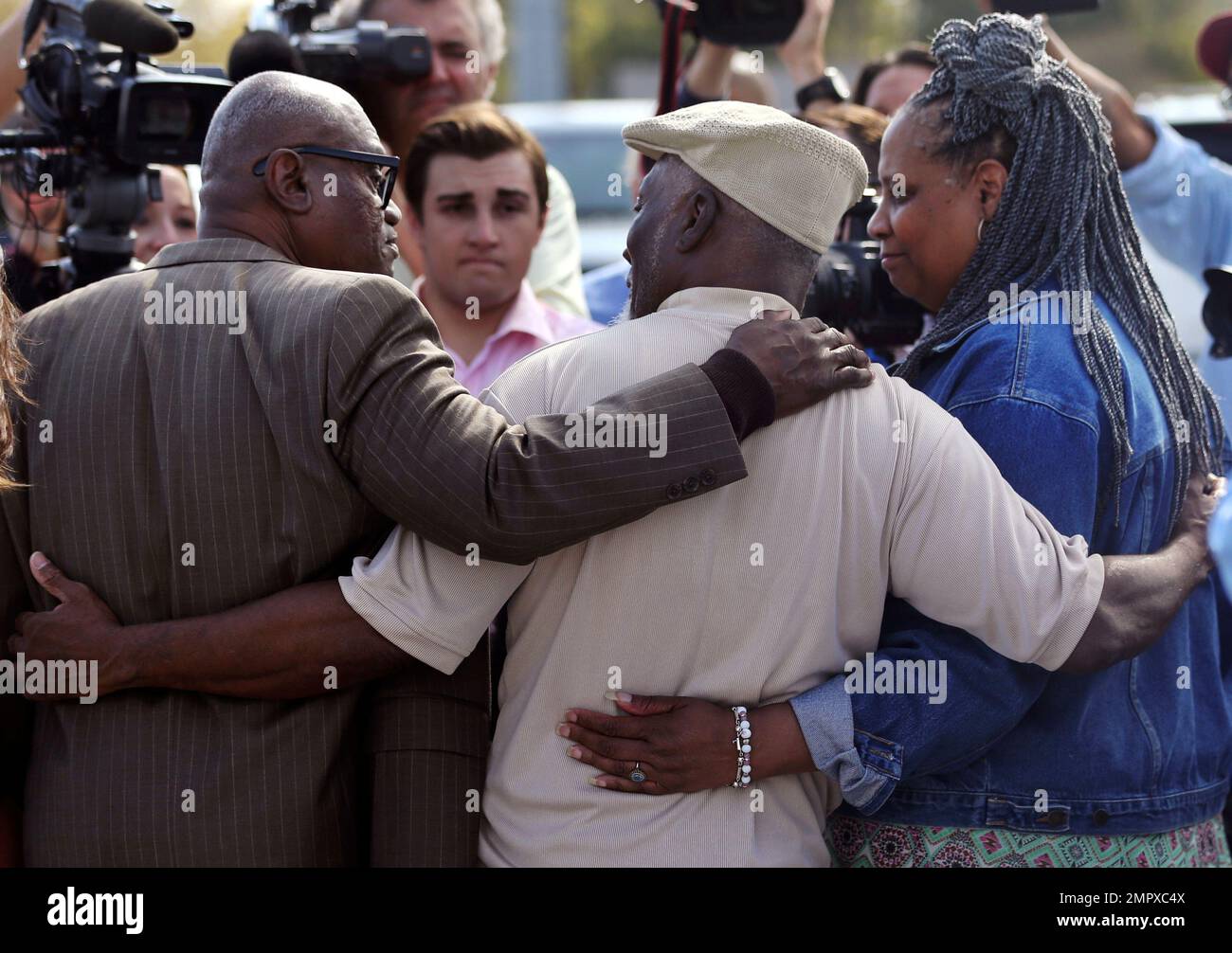 Wilbert Jones, left, embraces his brother brother Plem Jones, center ...